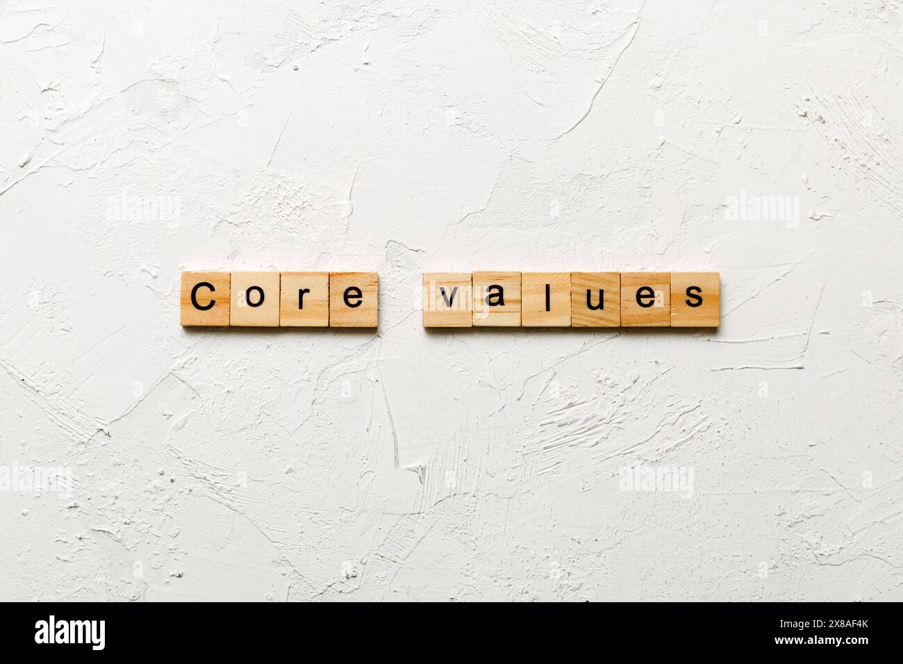 CORE VALUES word written on wood block. CORE VALUES text on cement ...