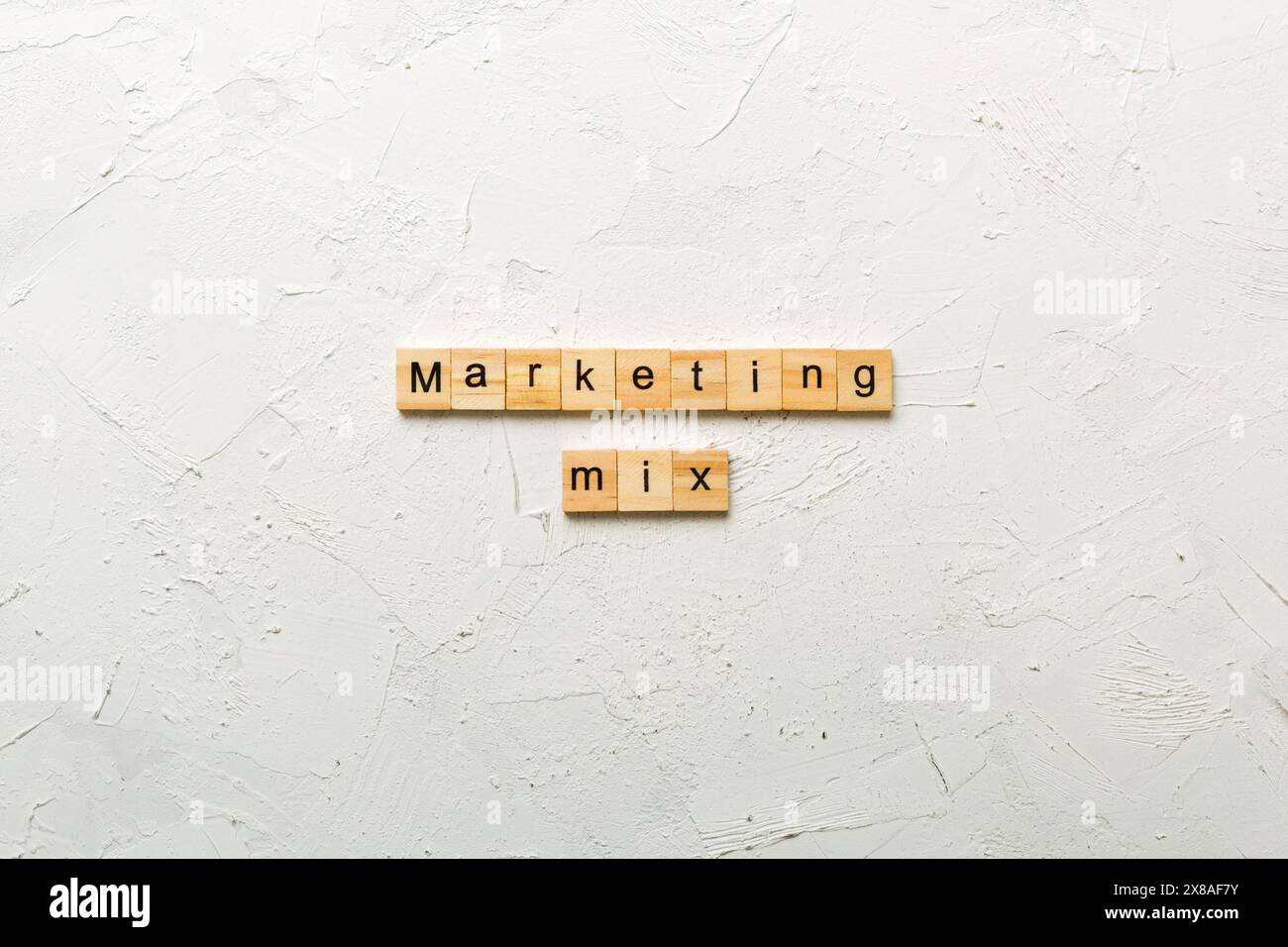 MARKETING MIX word written on wood block. MARKETING MIX text on cement ...