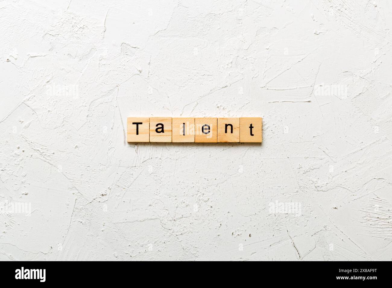 Talent word written on wood block. Talent text on cement table for your ...