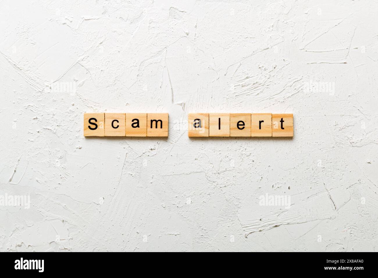 Scam alert word written on wood block. Scam alert text on table ... Scam alert word written on wood block. Scam alert text on table ...