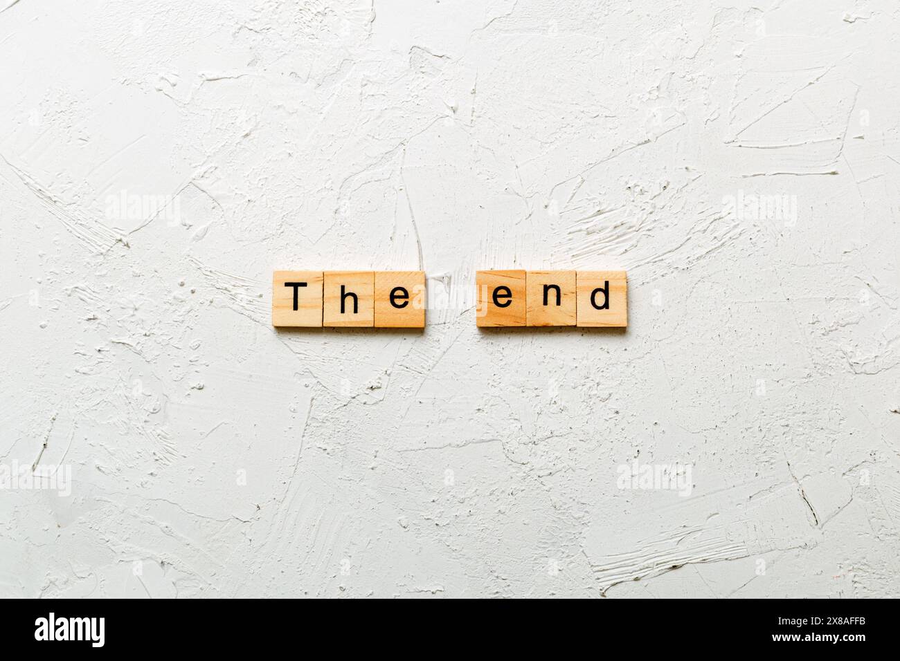 The end word written on wood block. The end text on cement table for your desing, concept Stock ...