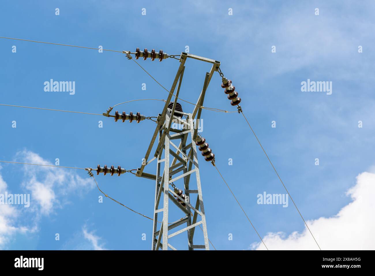 Ceramic insulators on electric poles and electrical wires passing on ...