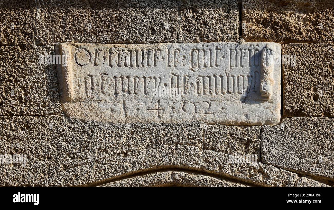 Stone slab with an engraved inscription on an old, historic wall ...