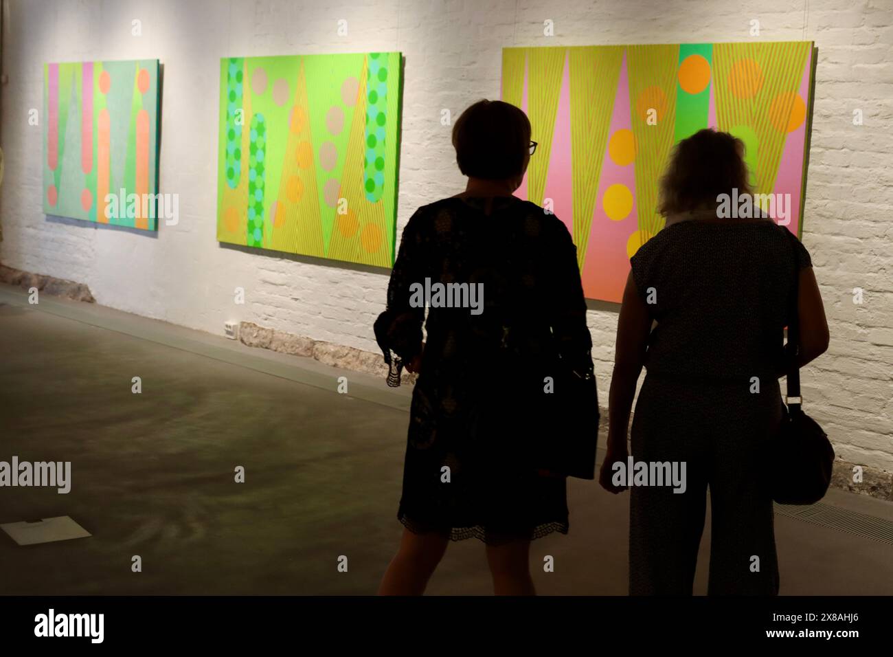 Guests at the opening of exhibition of paintings by artist Mari ...