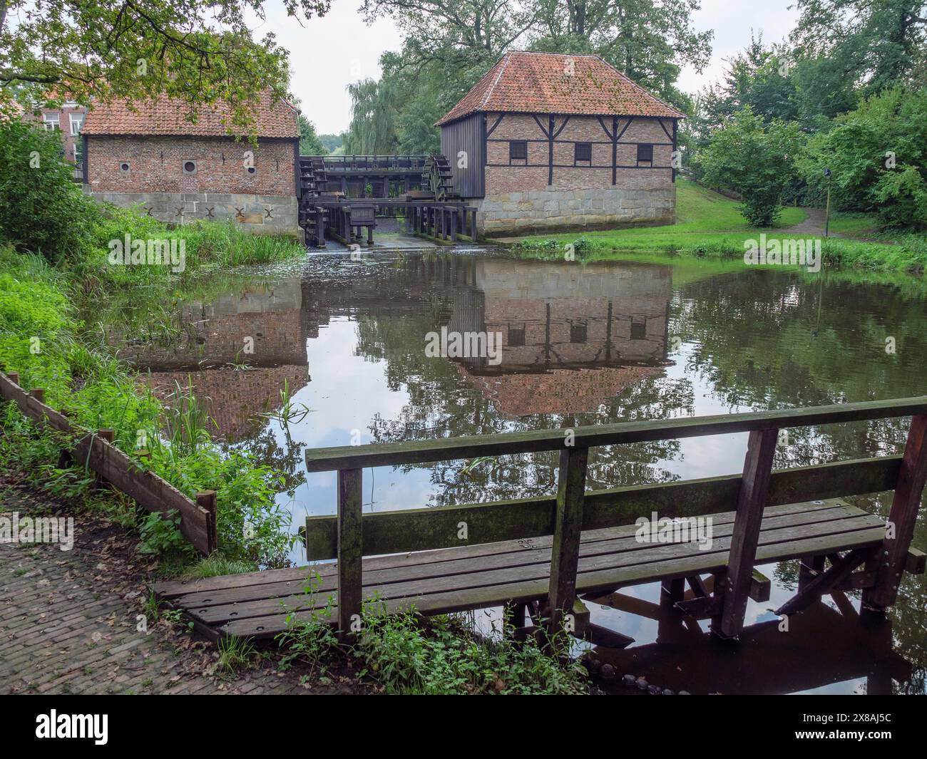 Historic watermill situated on a pond with brick and half-timbered ...