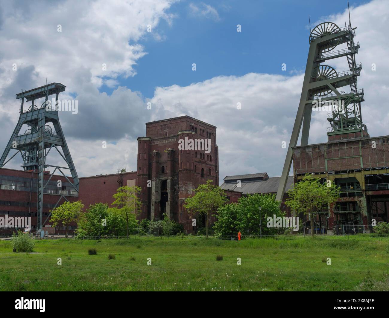 Industrial backdrop with winding tower and old brick buildings ...