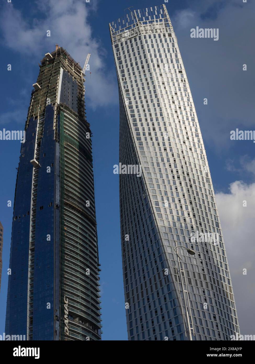 Two eye-catching skyscrapers in modern design, one under construction ...