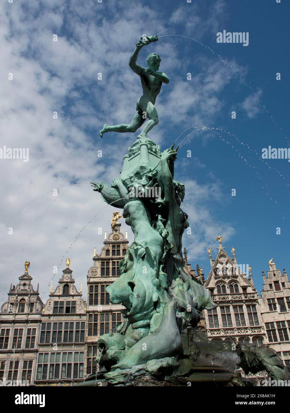 A bronze monument in front of historical buildings with detailed ...