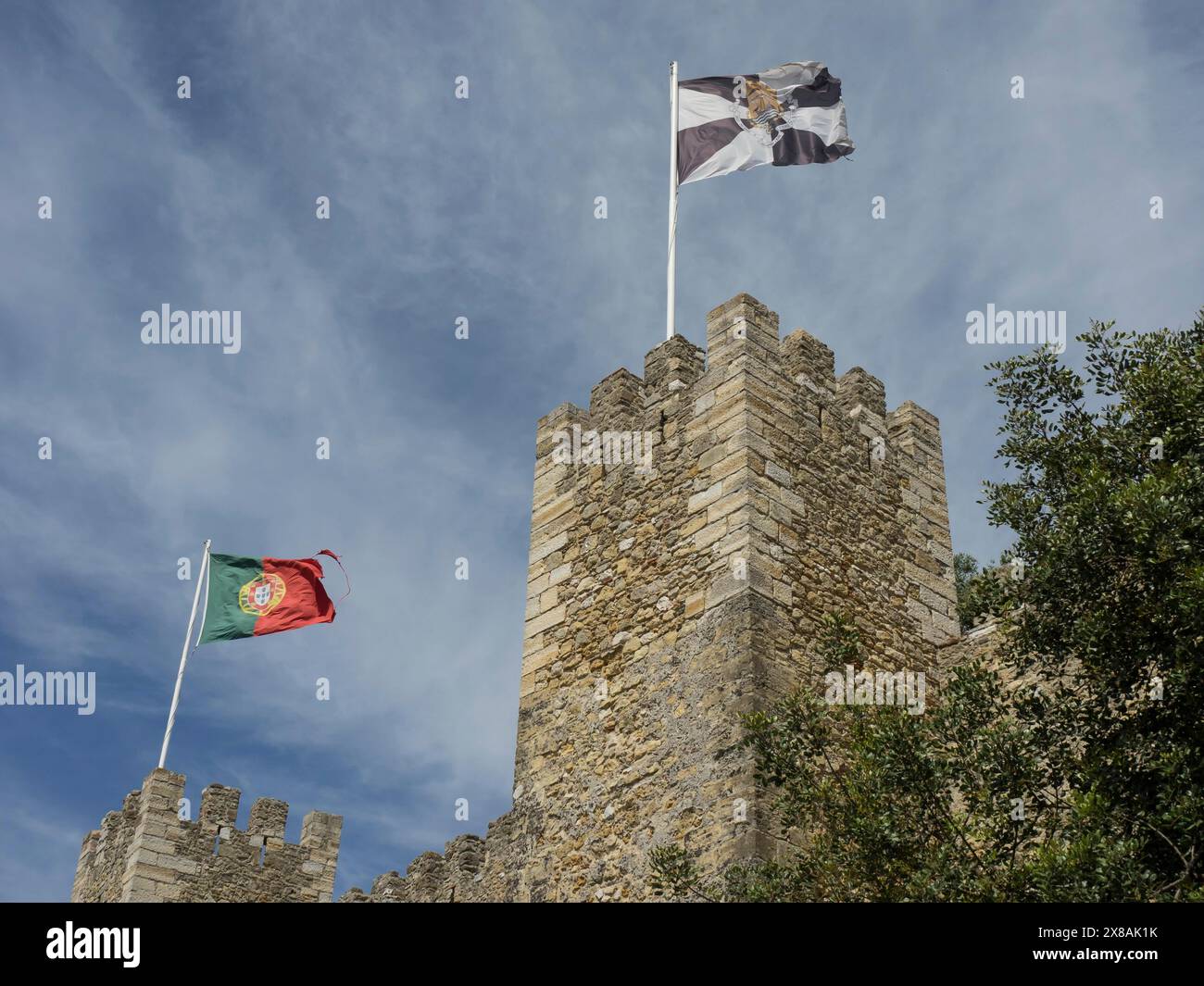 Castle tower with waving flag under a cloudy sky, Old fortress ...