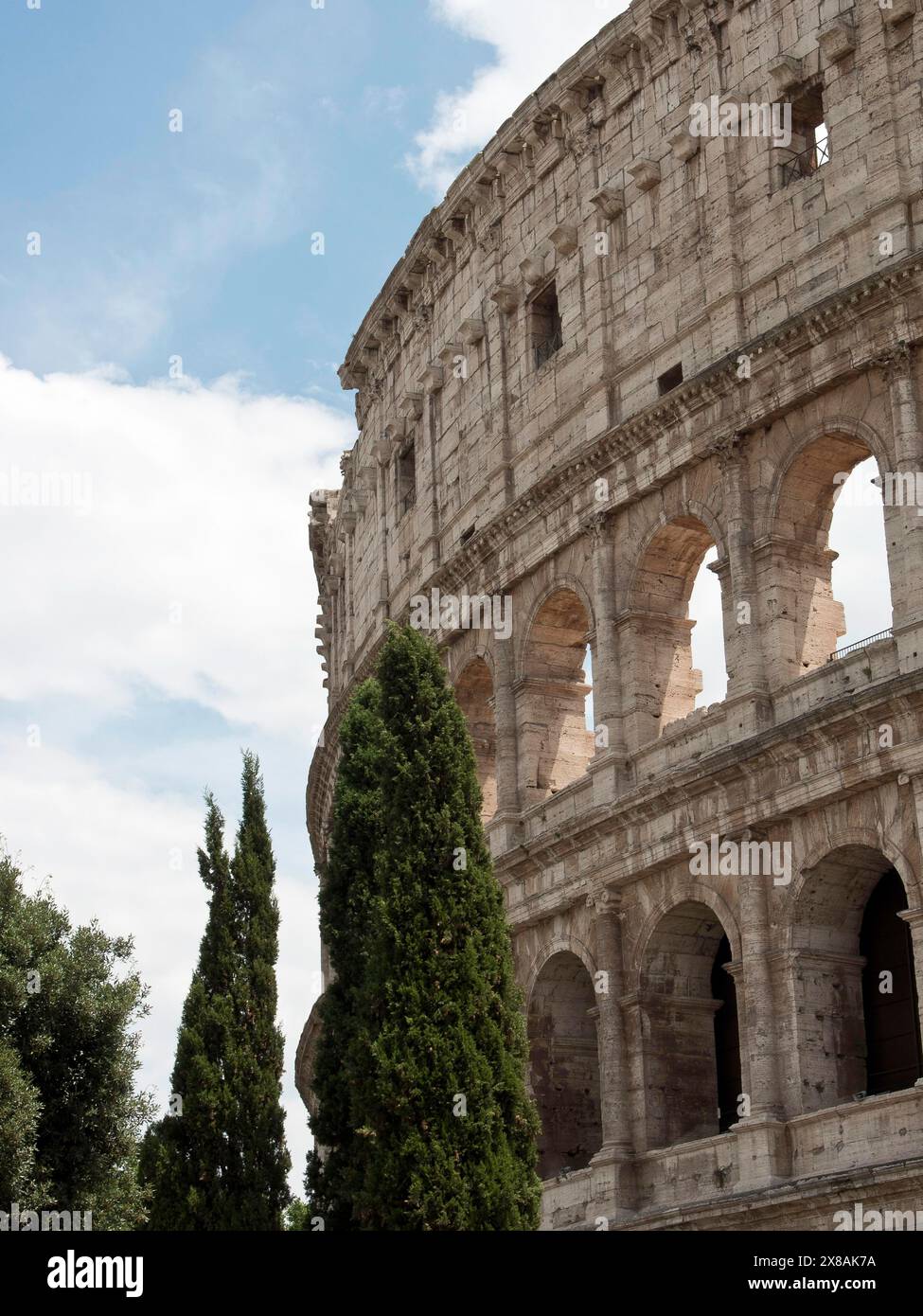 The ancient Colosseum with high architecture and surrounding nature ...