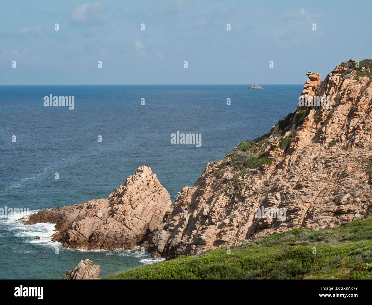Rough coastal landscape with cliffs and a view of the blue sea under a ...