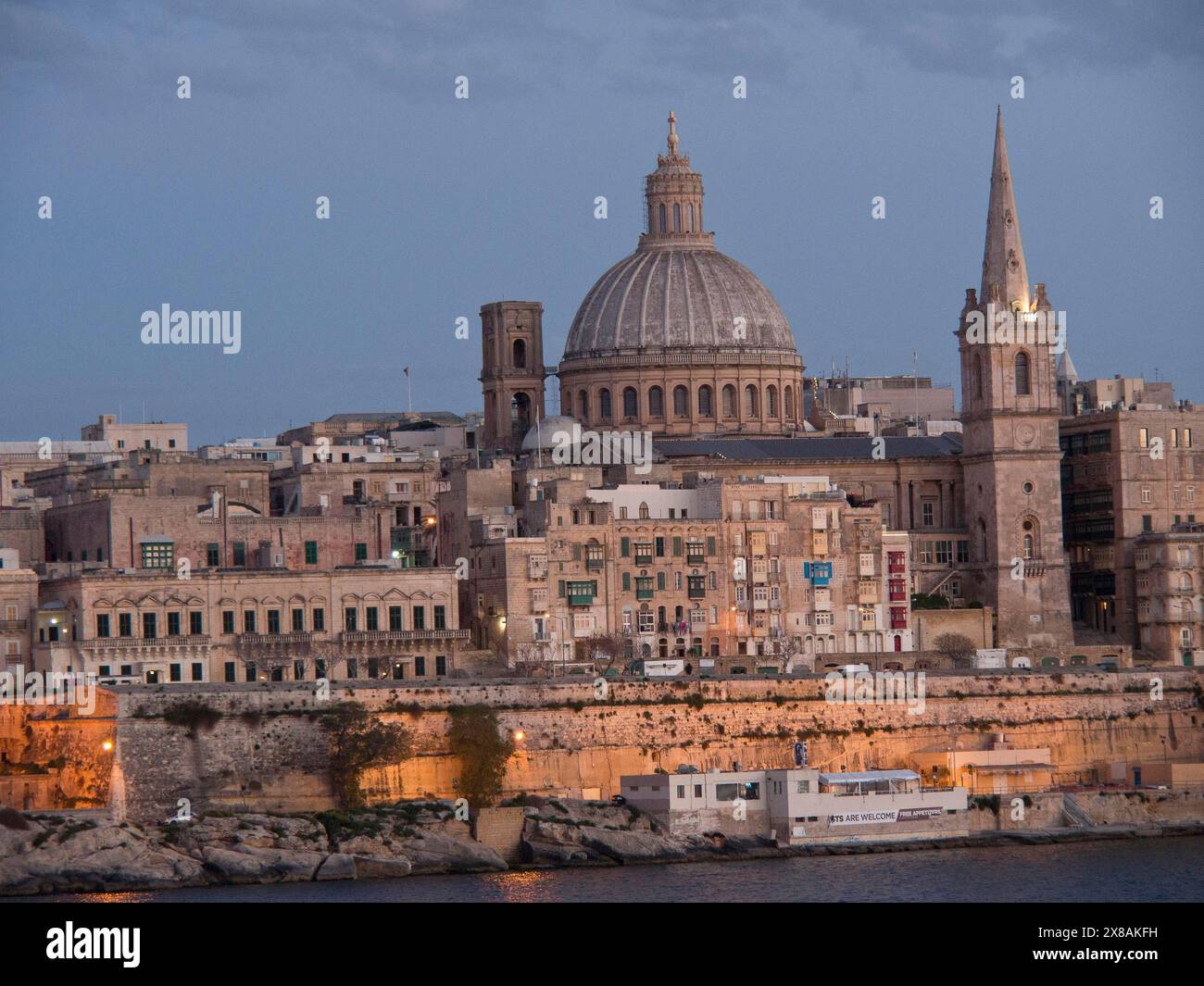 Historic cityscape at dusk with illuminated buildings and church on the ...