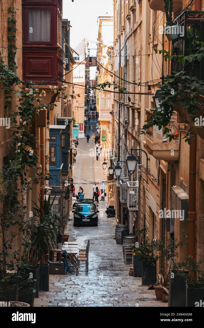 A picturesque narrow tiled street lined with colorful buildings and ...