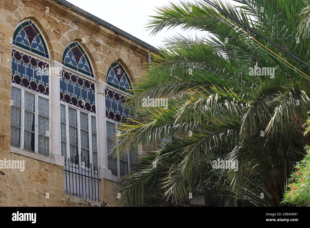 Lebanese traditional triple arch windows with branches of a palm tree ...