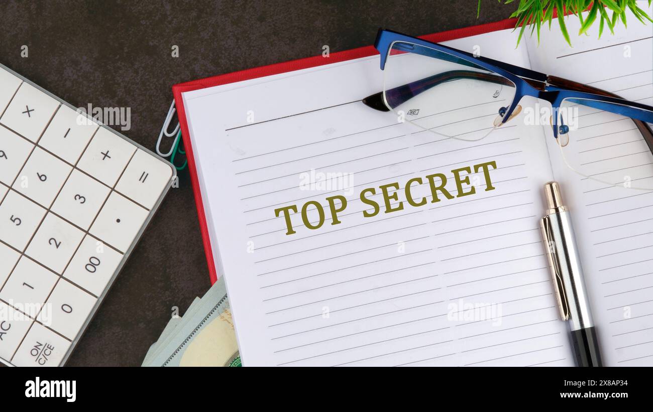 The sentence, Top Secret, written on the open page of the business ...