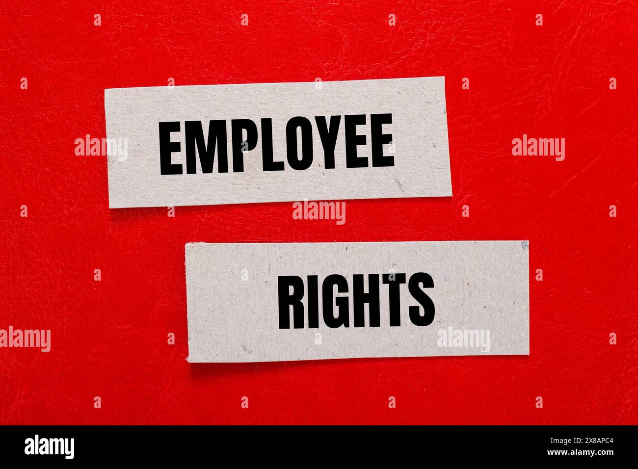 Employee rights words written on paper pieces with red background ...