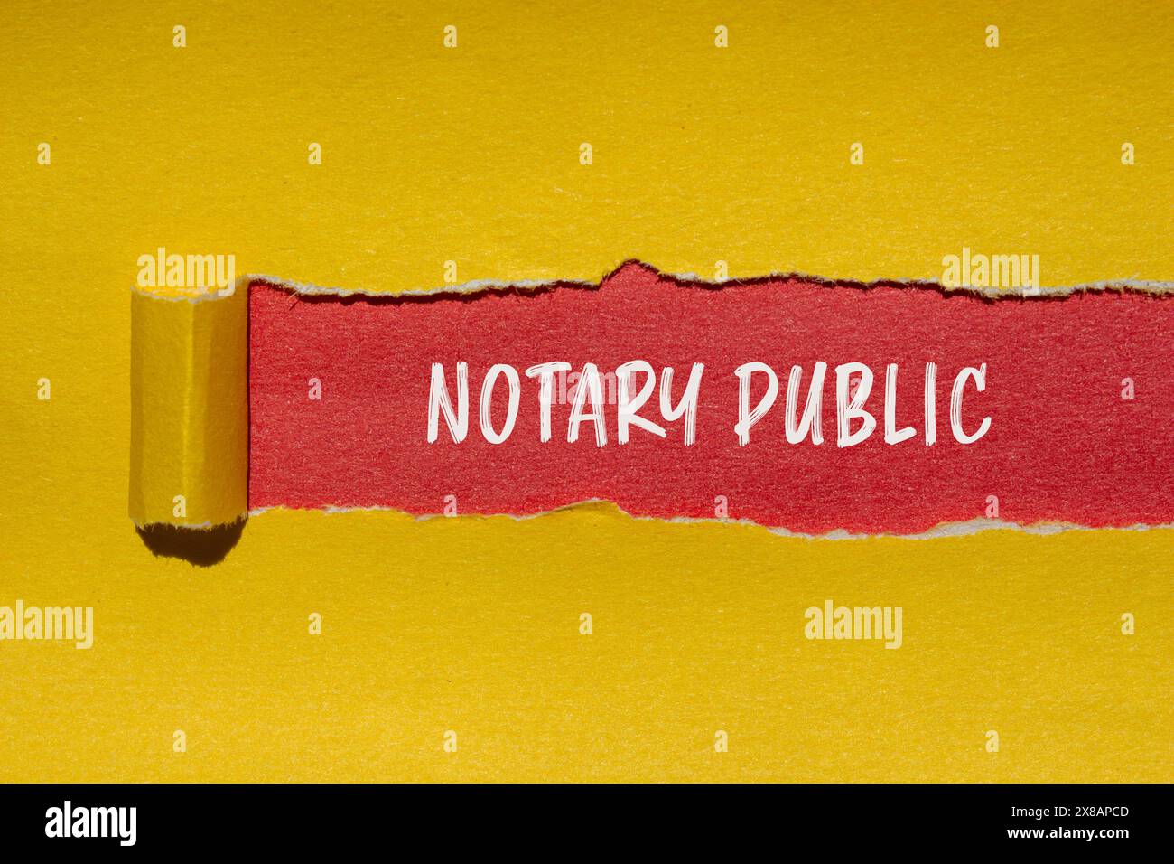 Notary public words written on ripped yellow paper with red background ...