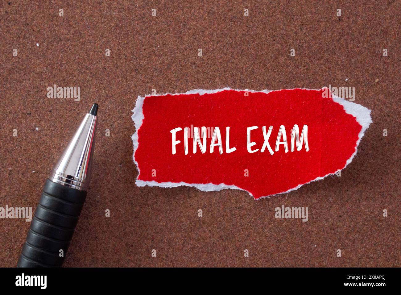 Final exam words written on ripped red paper with brown background ...