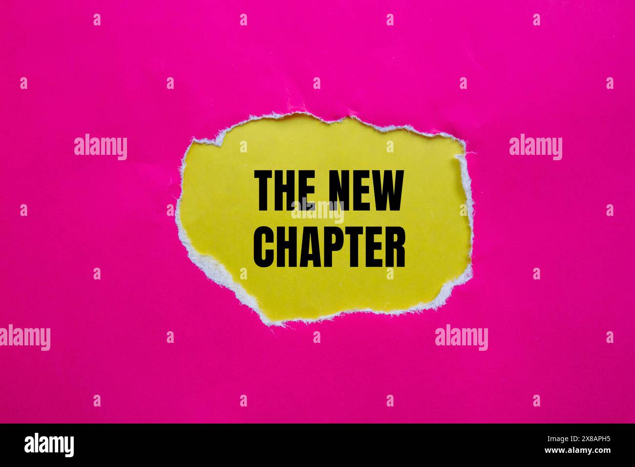 The new chapter words written on ripped pink paper with yellow ...