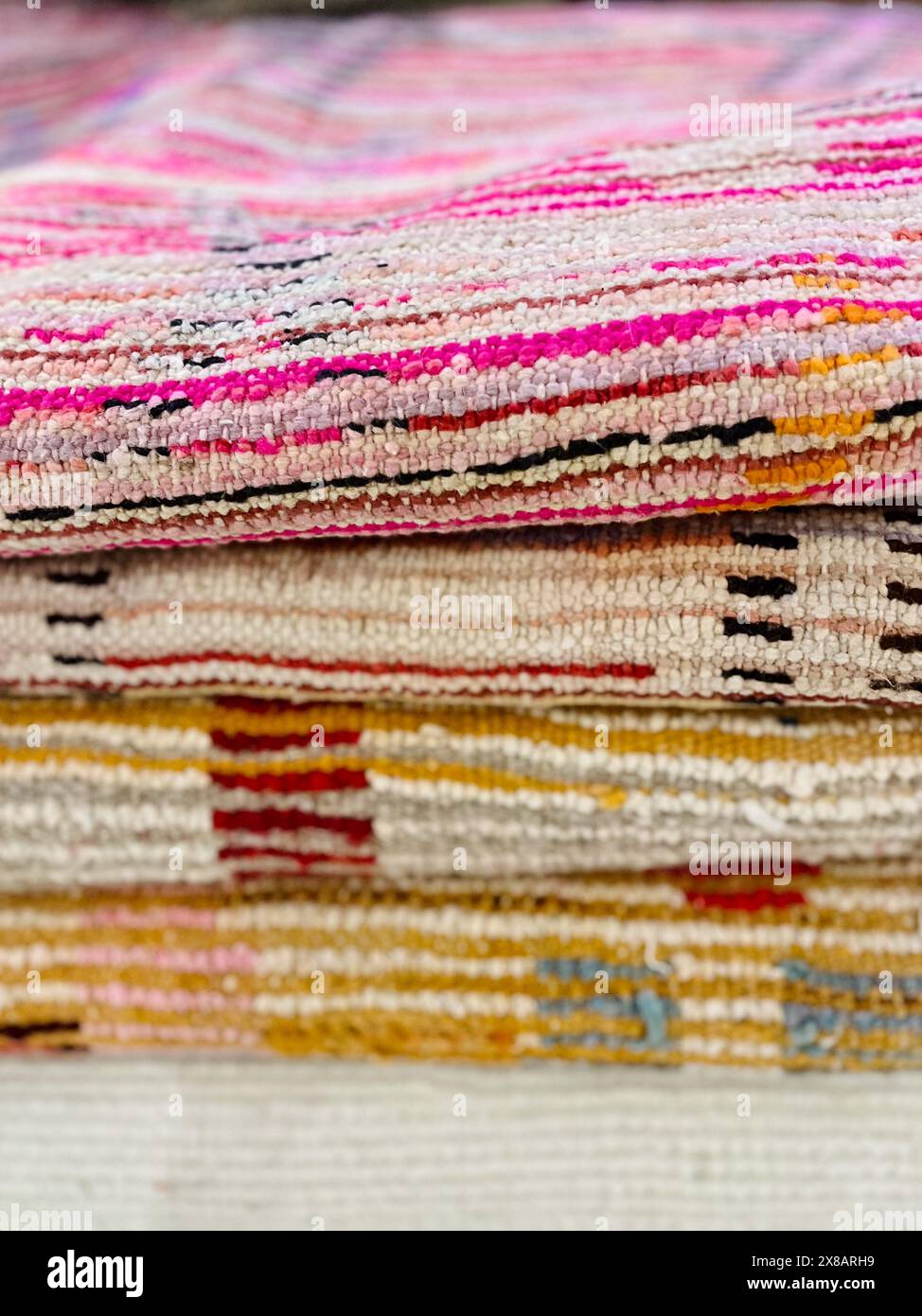 Close up of a stack of colorful rugs in a textile market in Moro Stock ...