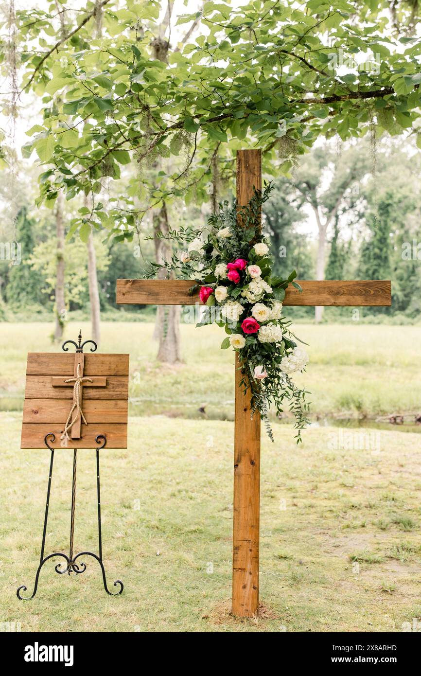Wooden cross with floral arrangement in an outdoor setting Stock Photo ...