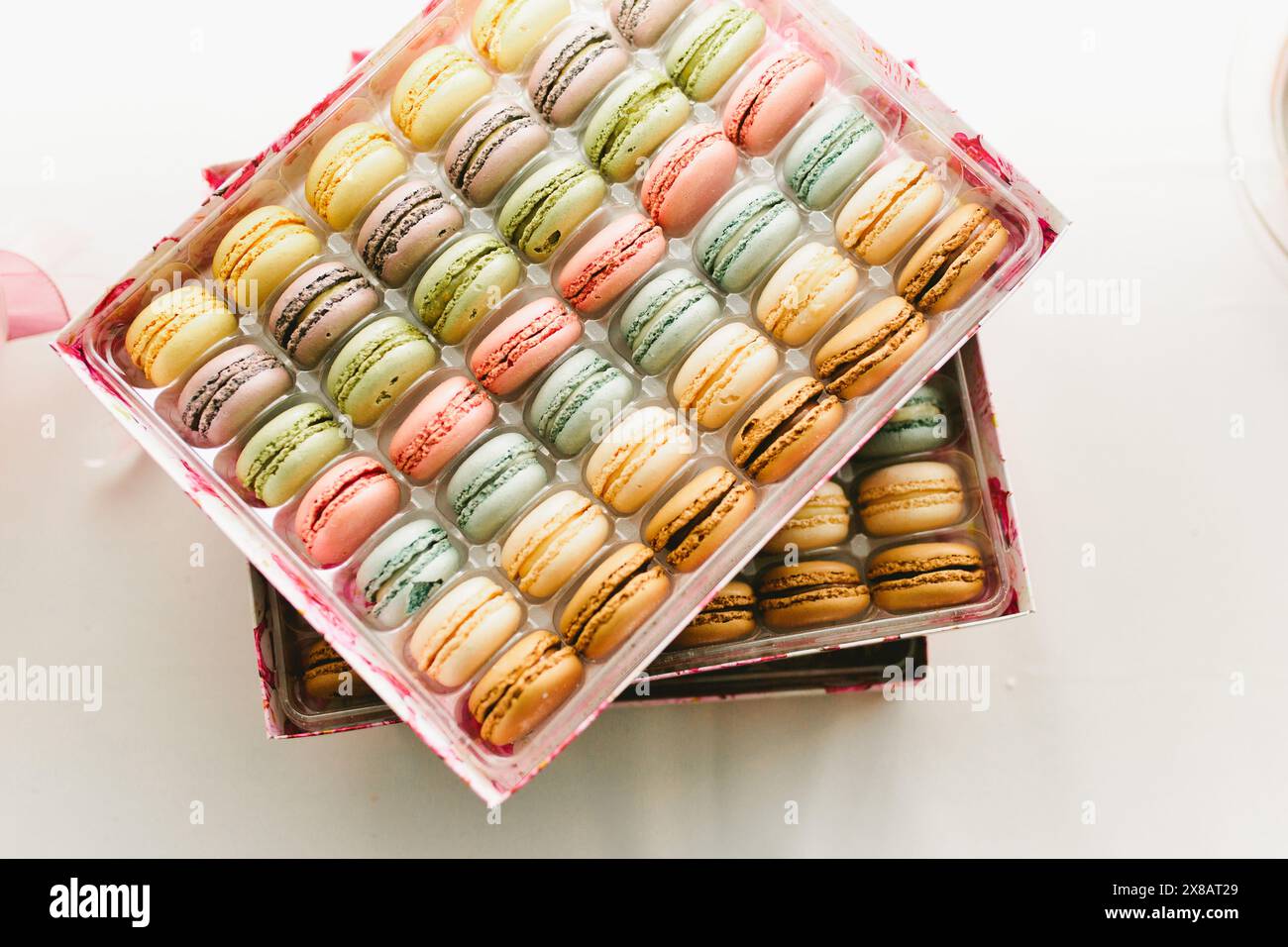 Colorful macaron assorted boxes stacked on table Stock Photo - Alamy