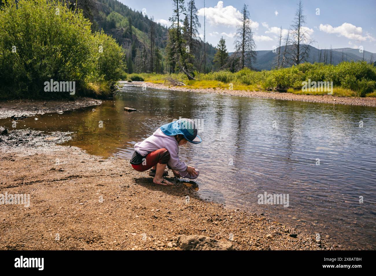 Family with child playing in the river hi-res stock photography and ...