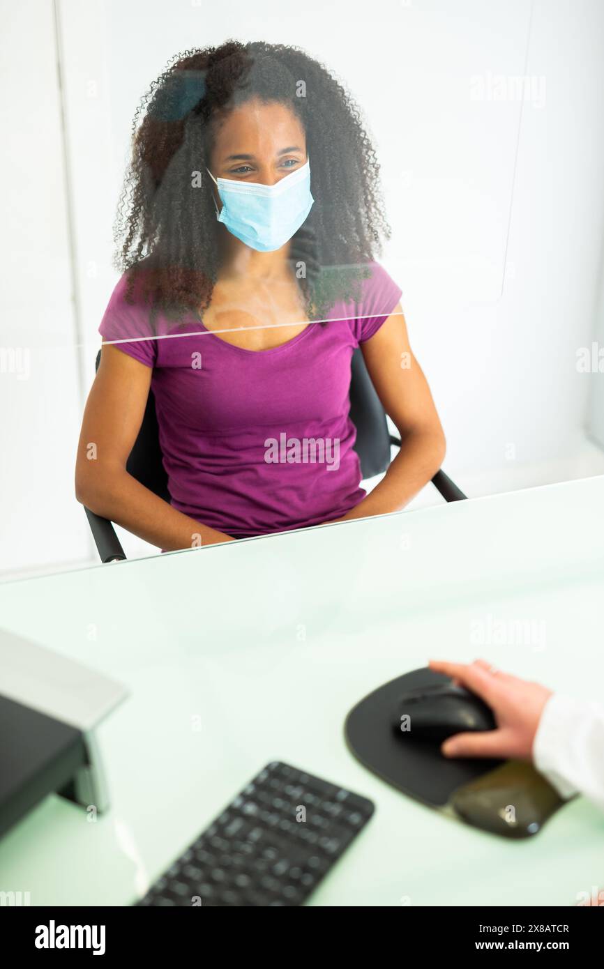 Patient wearing blue surgical masks at the doctor's office, having a ...