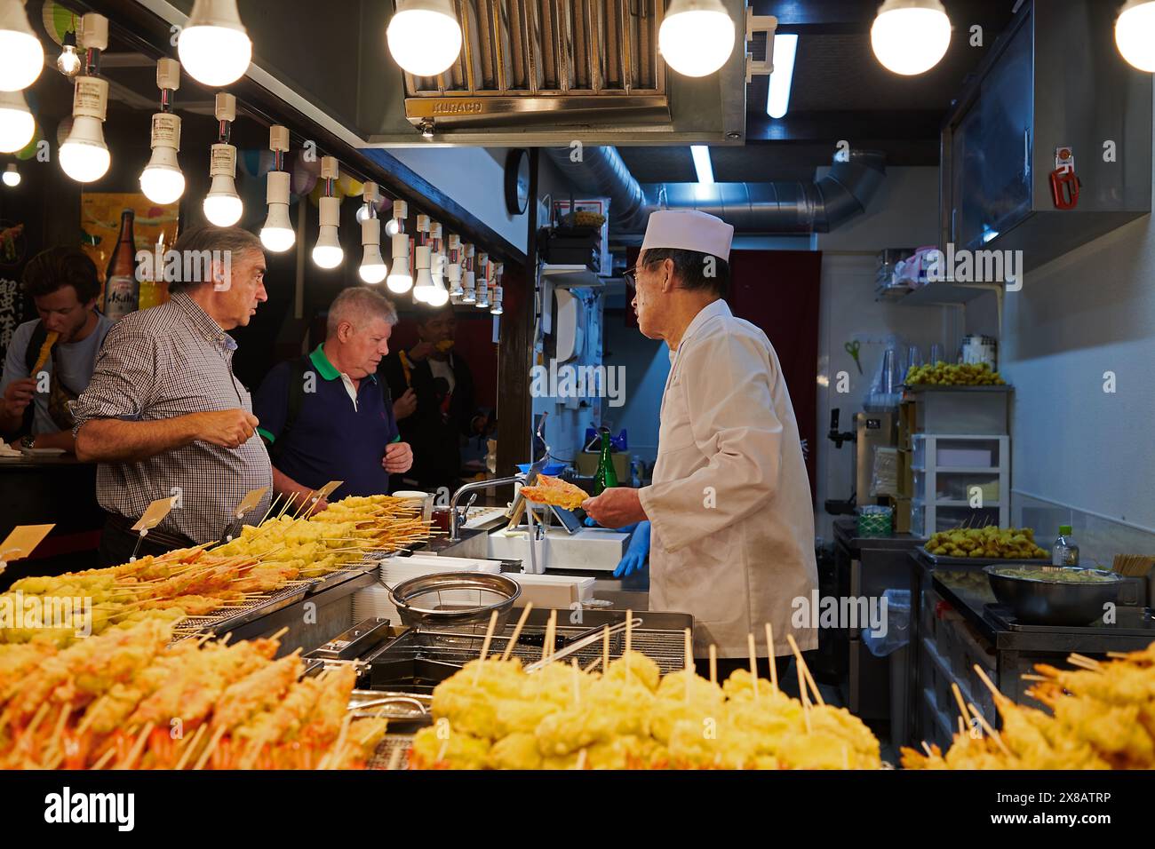 Japanese chef in tempura stall serving fried prawn Stock Photo - Alamy