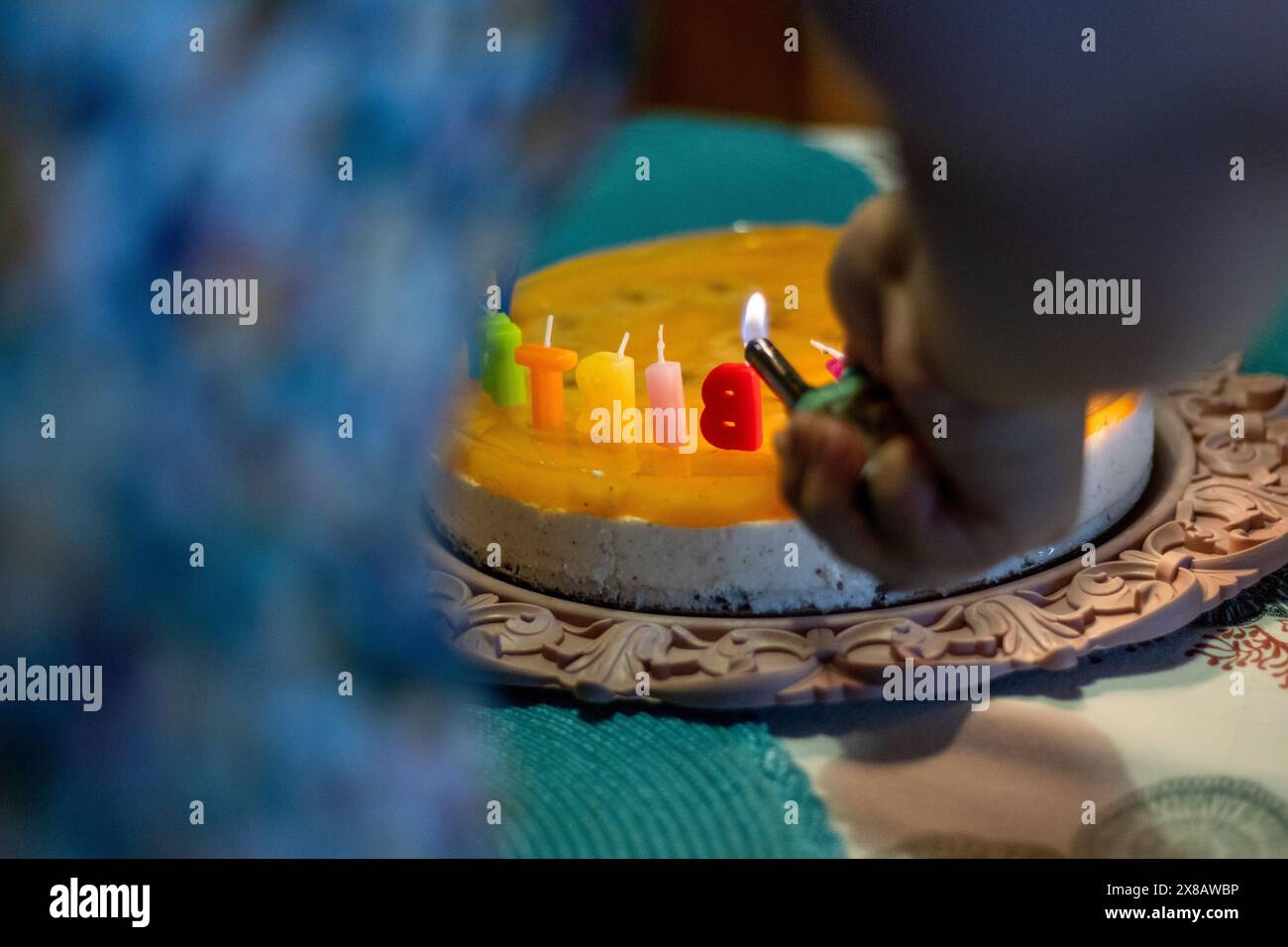 Lighting up a home-made fruity birthday cake Stock Photo - Alamy