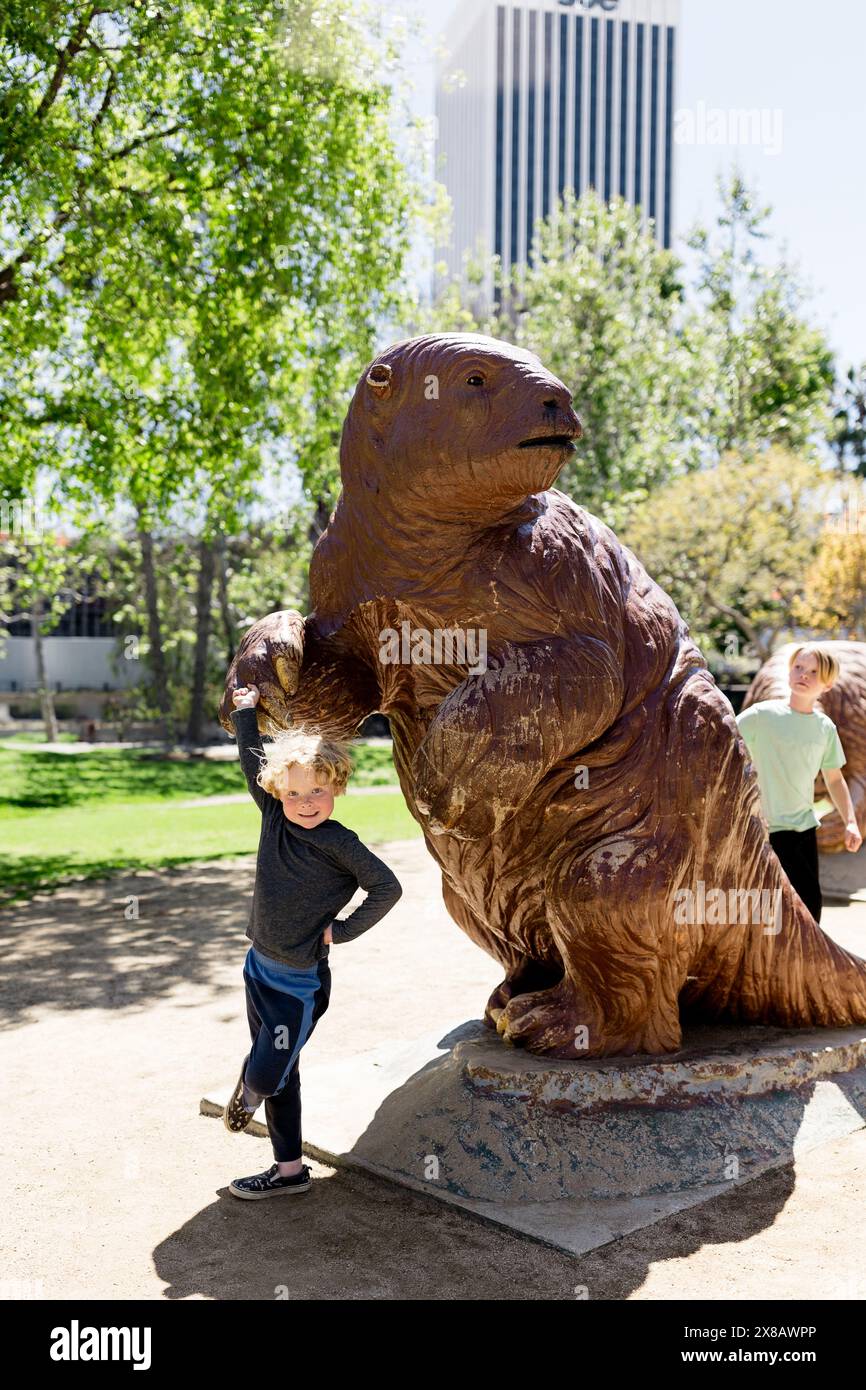 Five Year Old Boy Fist Bumping Sloth Statue in Los Angeles Stock Photo ...