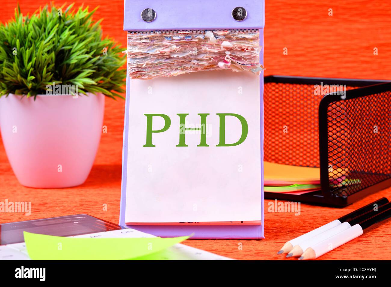 Letters PHD on a desktop calendar with tear-off sheets Stock Photo - Alamy