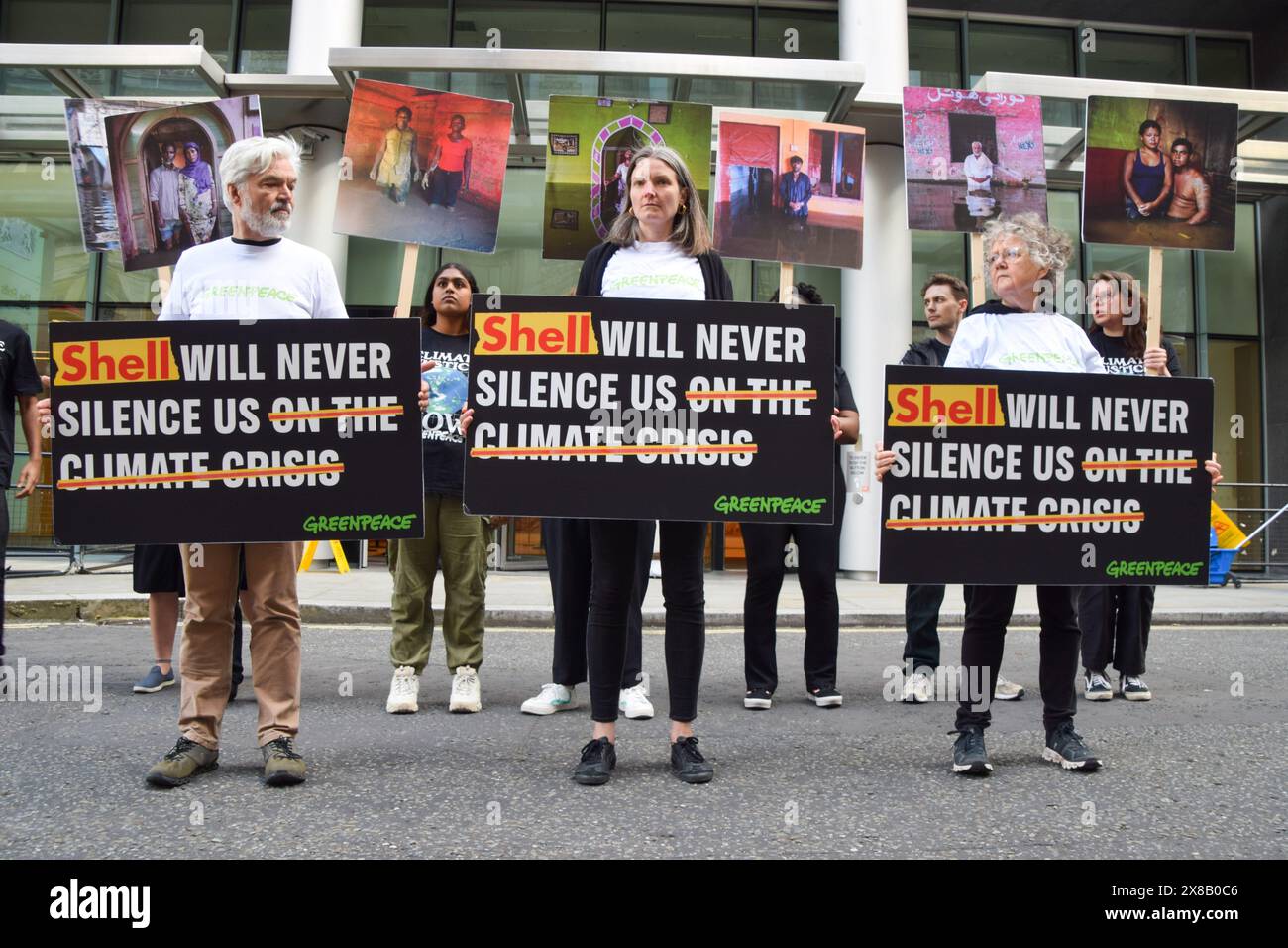 London, UK. 24th May 2024. Greenpeace activists stand with placards and ...