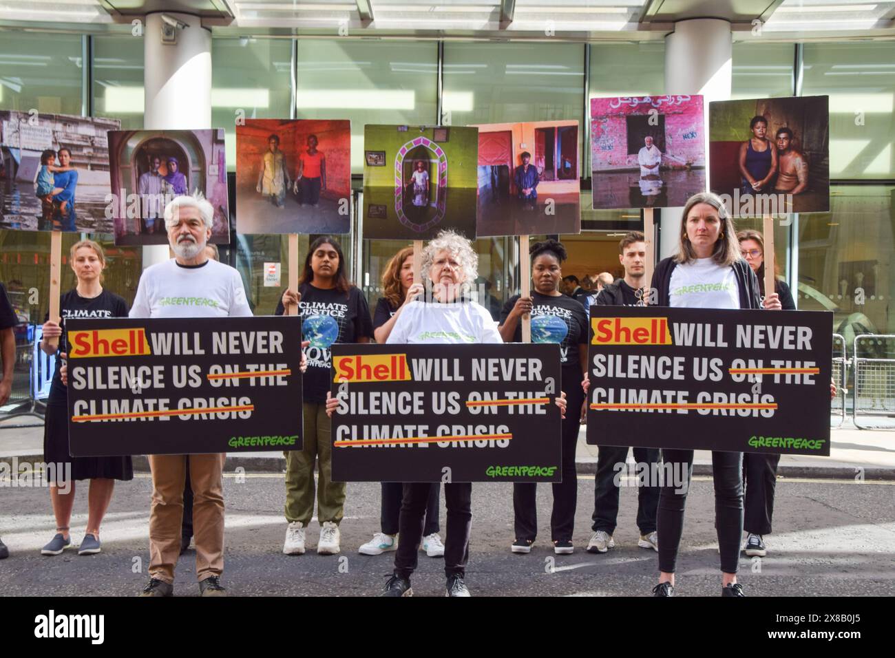 London, UK. 24th May 2024. Greenpeace activists stand with placards and ...