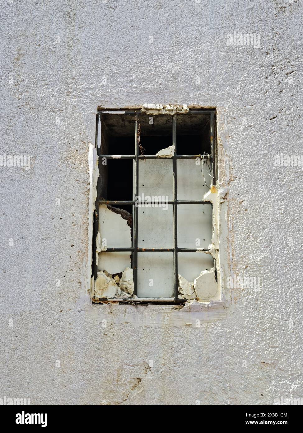 Partially covered window with bars Stock Photo - Alamy