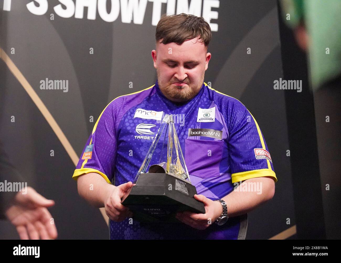 London, UK. 23rd May, 2024. Luke Littler inspects his trophy during the ...