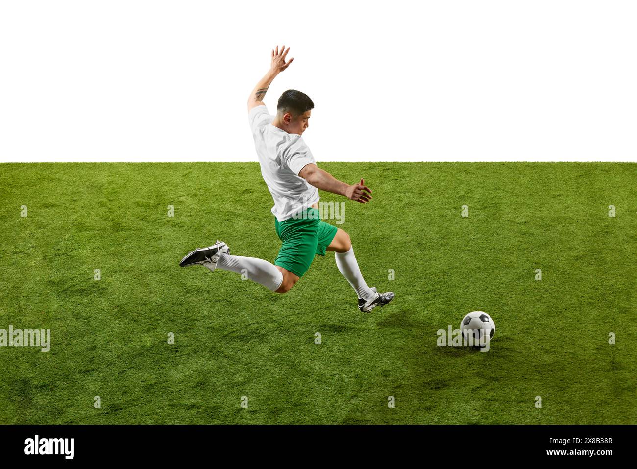 Side view of soccer player in green shorts and white jersey, captured ...