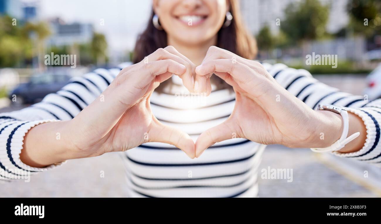 Business, heart and hands with woman in city for gratitude message ...