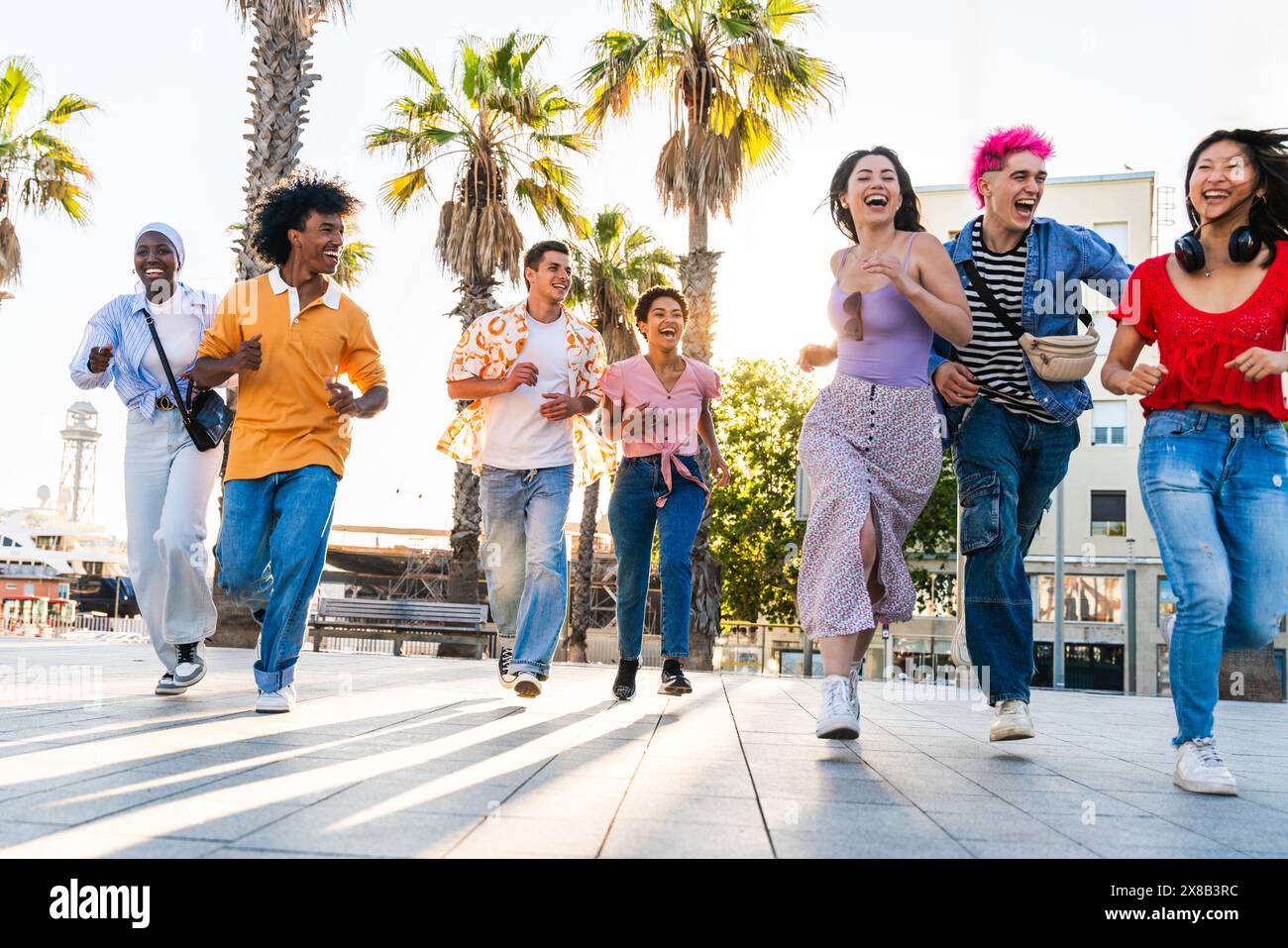 Multiethnic group of young happy friends hanging out in the city ...