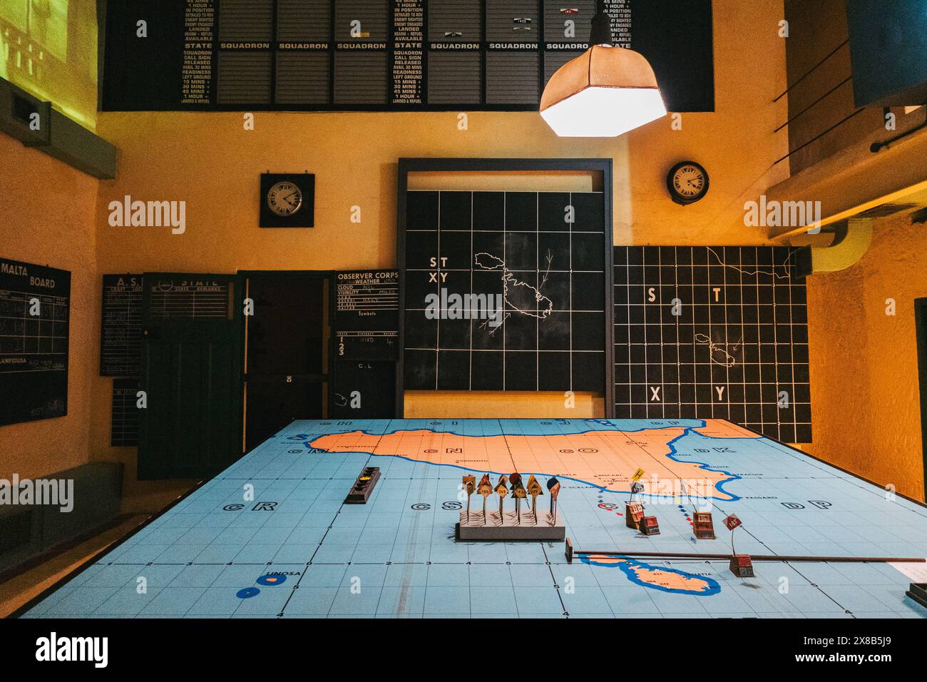 A World War II-era sand table, surrounded by military charts and blackboards at the Lascaris War ...