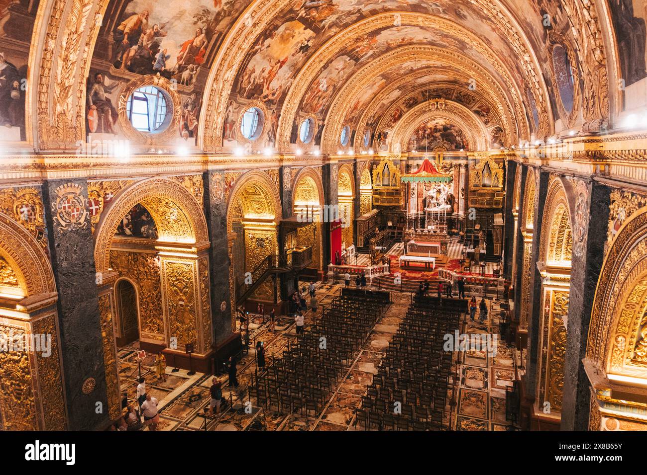 Inside St. John's Co-Cathedral in Valletta, Malta: golden walls, arched ...