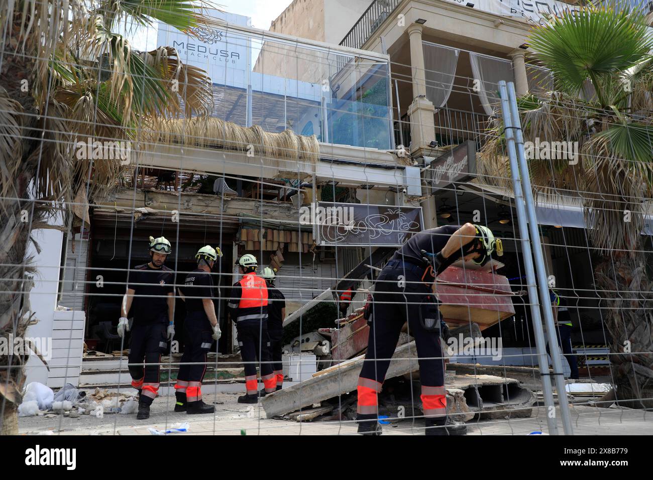 24 May 2024, Spain, Palma: Firefighters work at the site of the ...