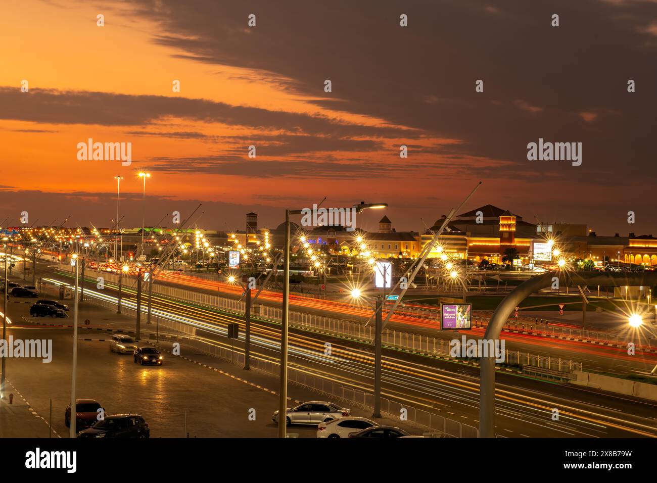 Doha Roads and traffic light trail at sunset time. Sunset view Al Waab ...
