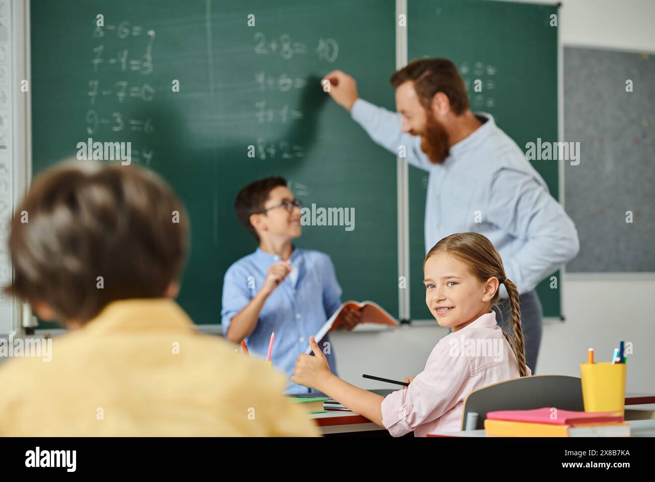 A group of diverse children listening attentively to their male ...