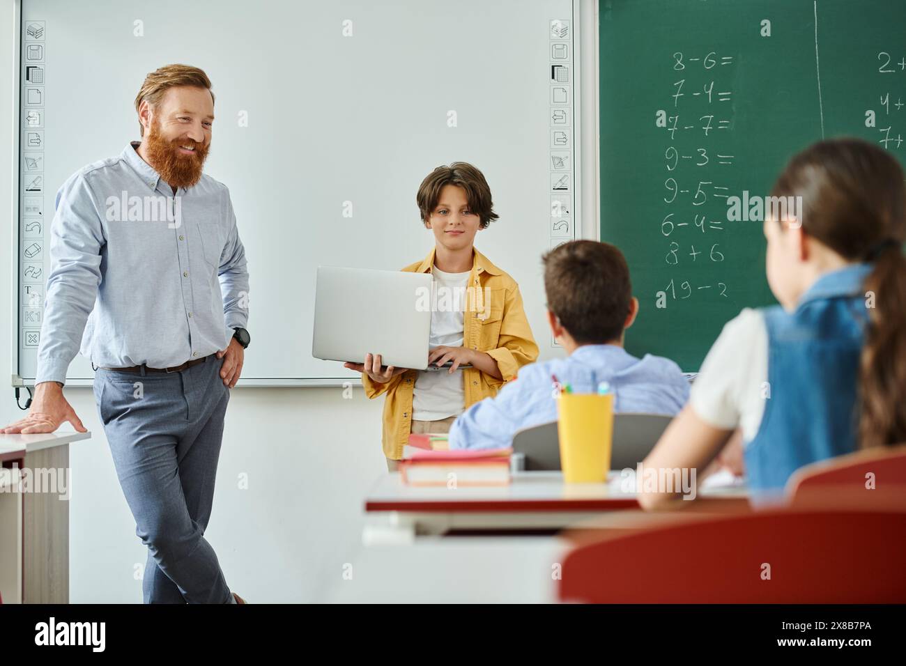 A man teacher standing confidently in front of a diverse group of kids ...