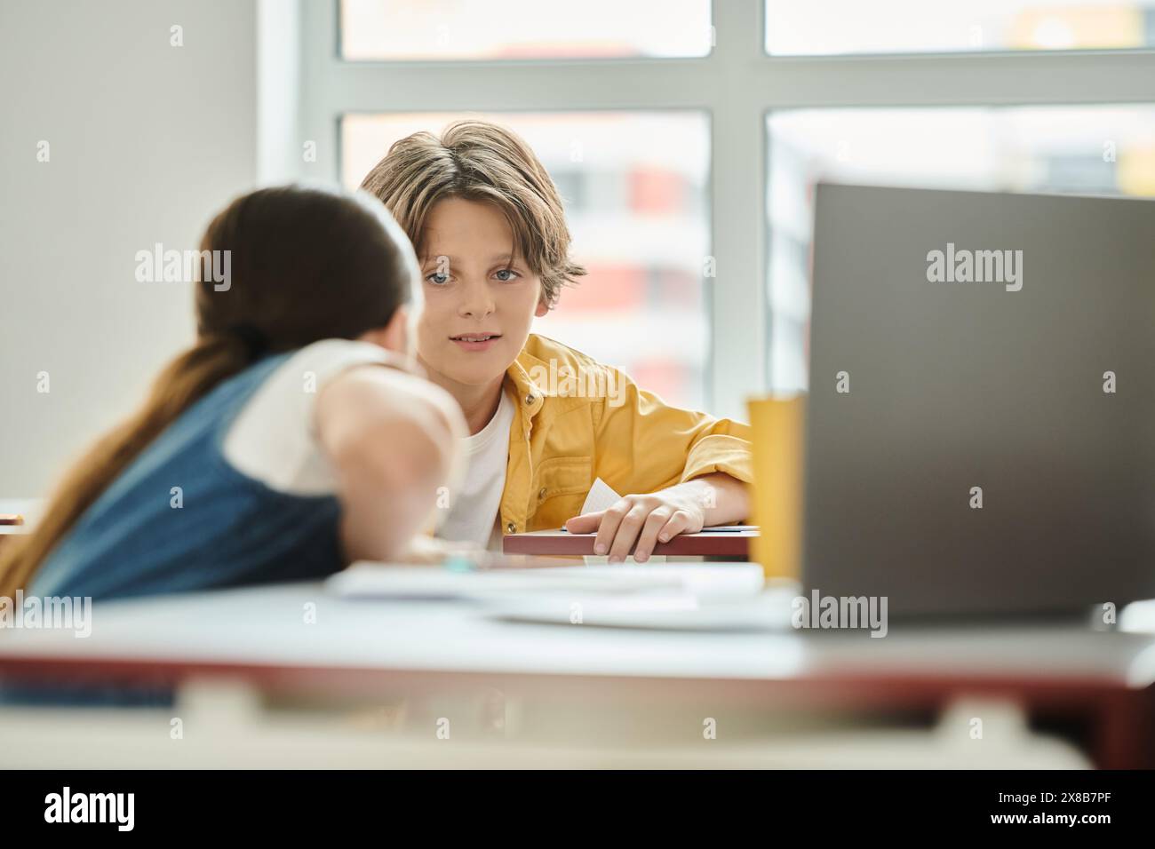 kids at a desk in front of a computer screen in a modern office setting ...