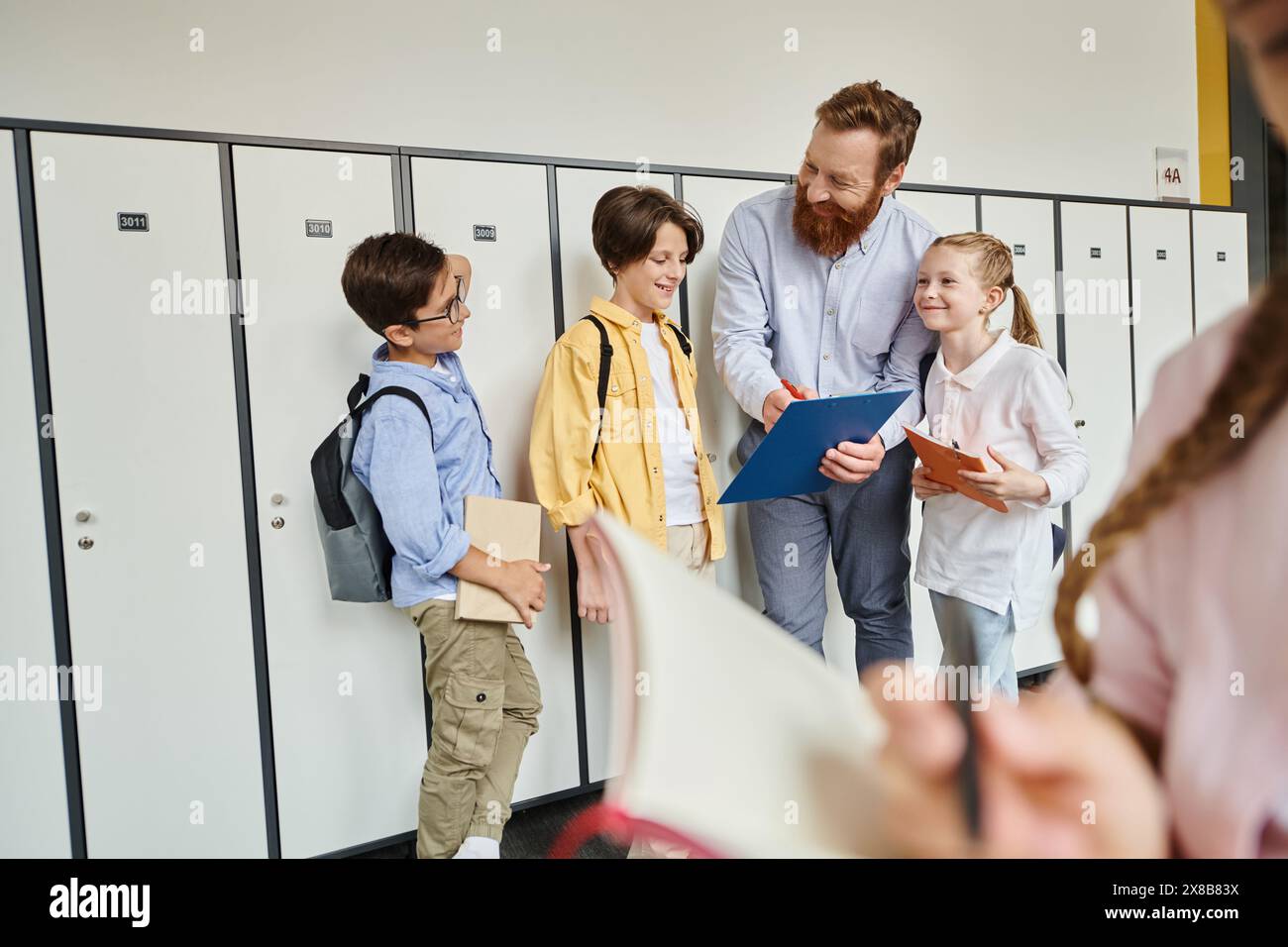 A male teacher instructs a diverse group of kids in a bright, lively ...