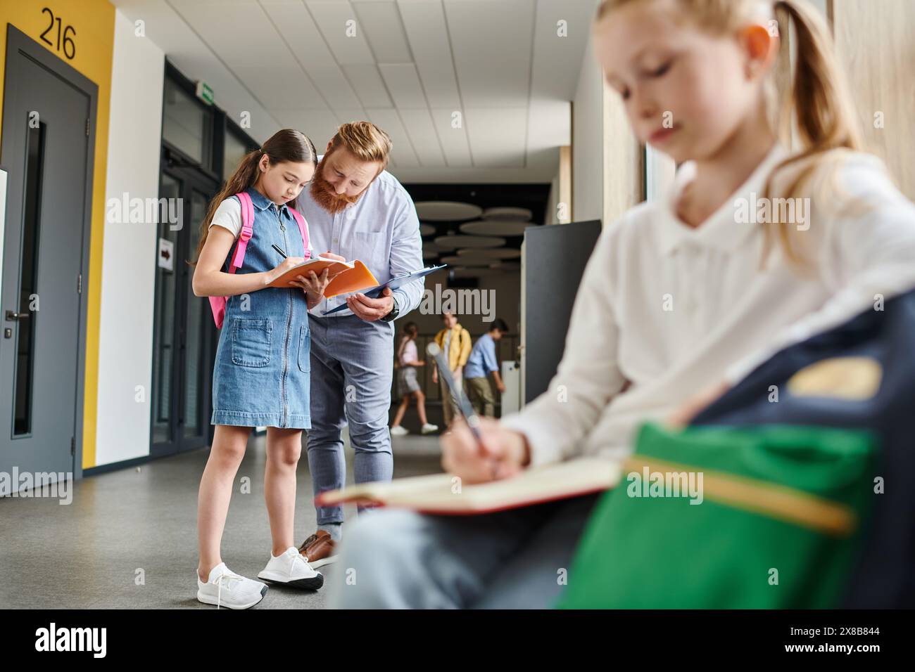 A man teacher is instructing a diverse group of kids, standing in a ...
