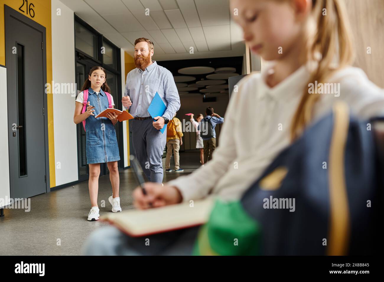 A diverse group of children standing attentively in a hallway as their ...