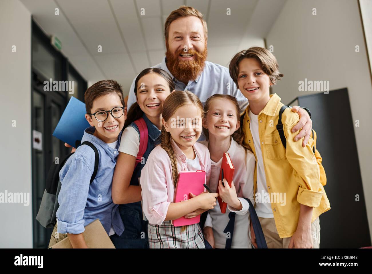 A man teacher engages with a diverse group of children in a lively ...